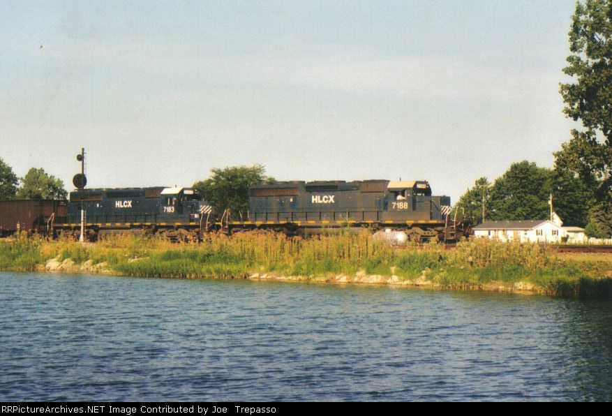 HLCX 7188, 7183 take roll by Lake Deshler.